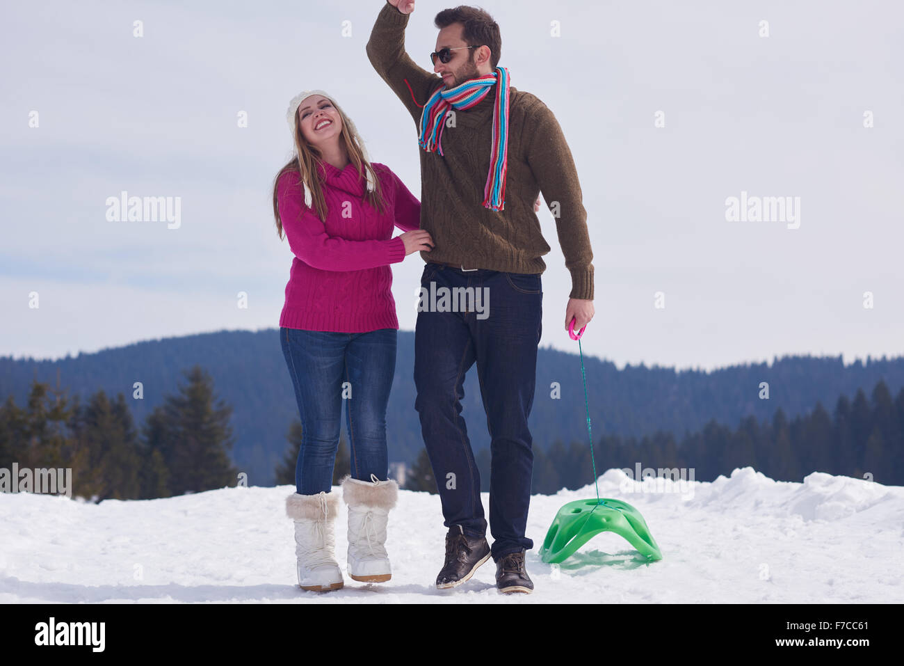 romantic winter scene, happy young couple having fun on fresh show on ...