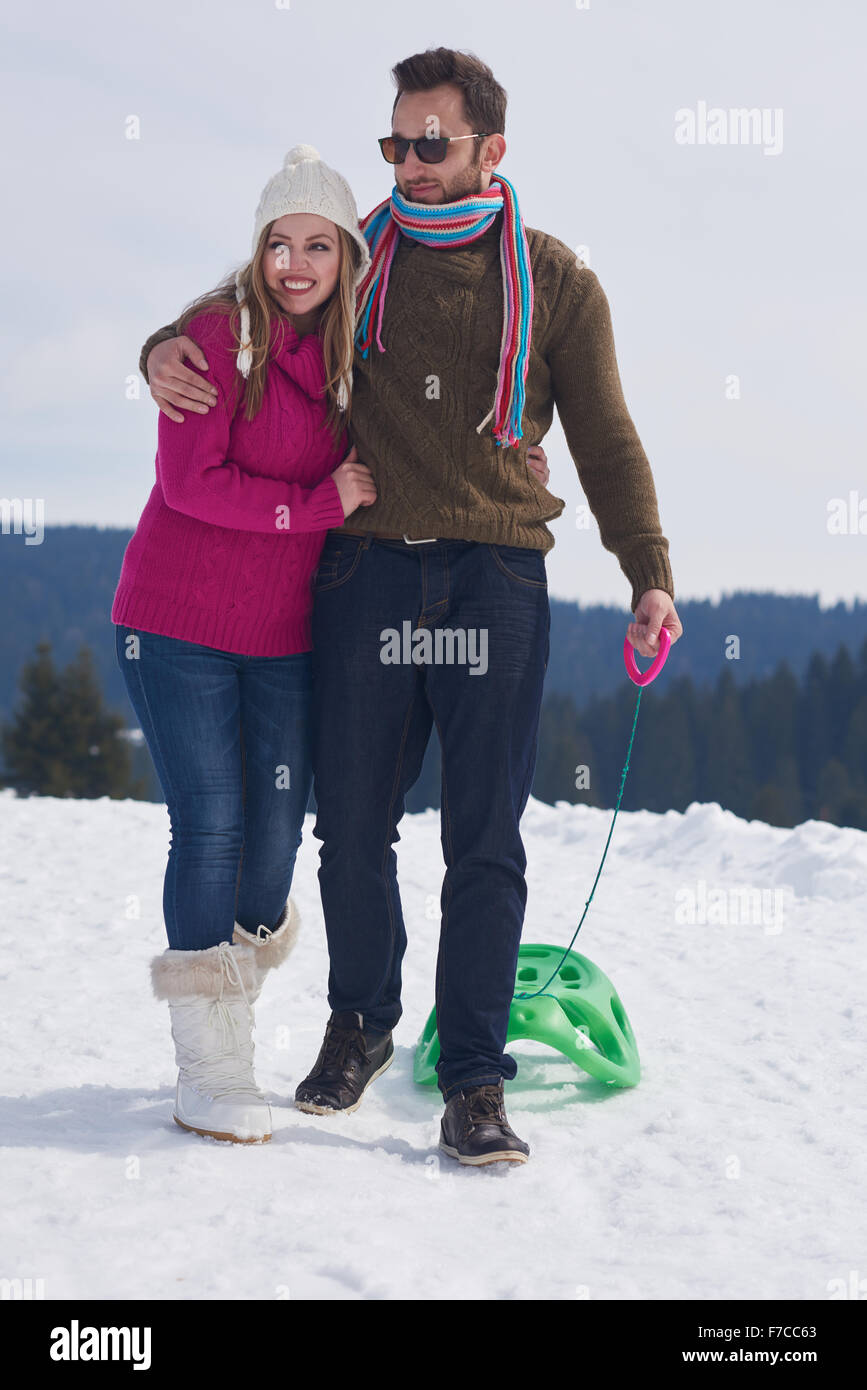 romantic winter scene, happy young couple having fun on fresh show on ...
