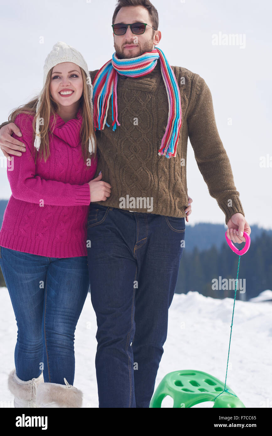 romantic winter scene, happy young couple having fun on fresh show on ...