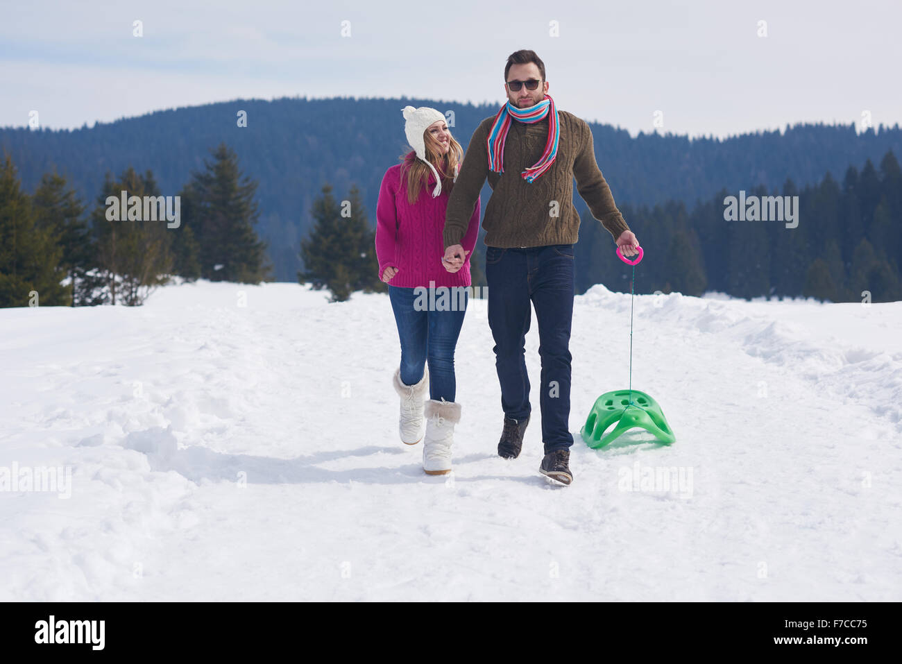 romantic winter scene, happy young couple having fun on fresh show on ...