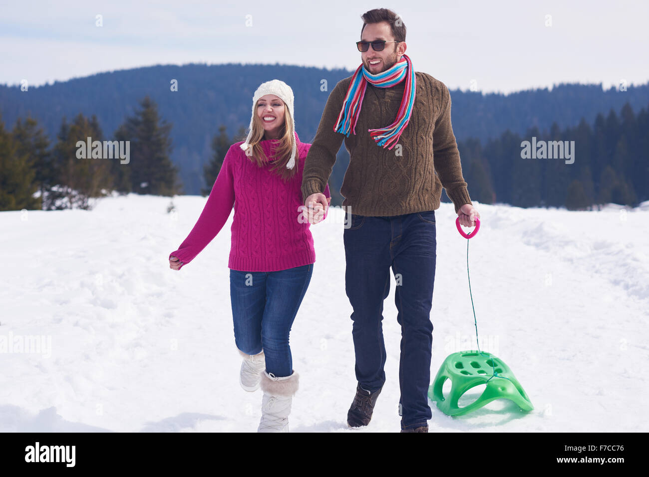 romantic winter scene, happy young couple having fun on fresh show on ...