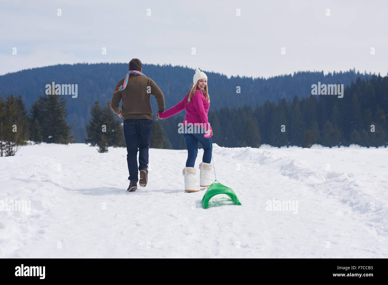 romantic winter scene, happy young couple having fun on fresh show on ...