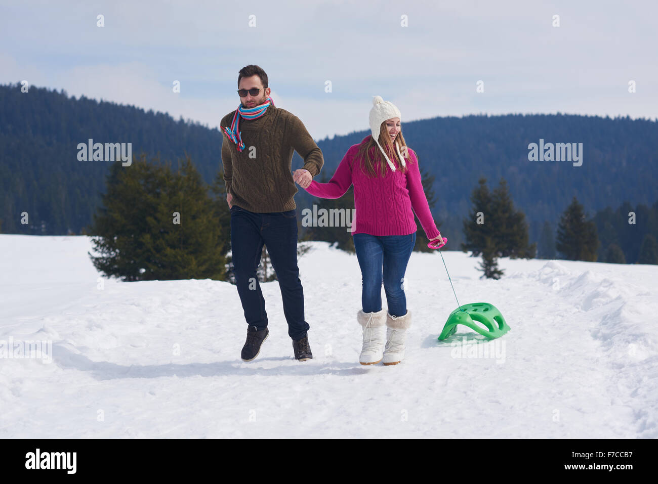 romantic winter scene, happy young couple having fun on fresh show on ...
