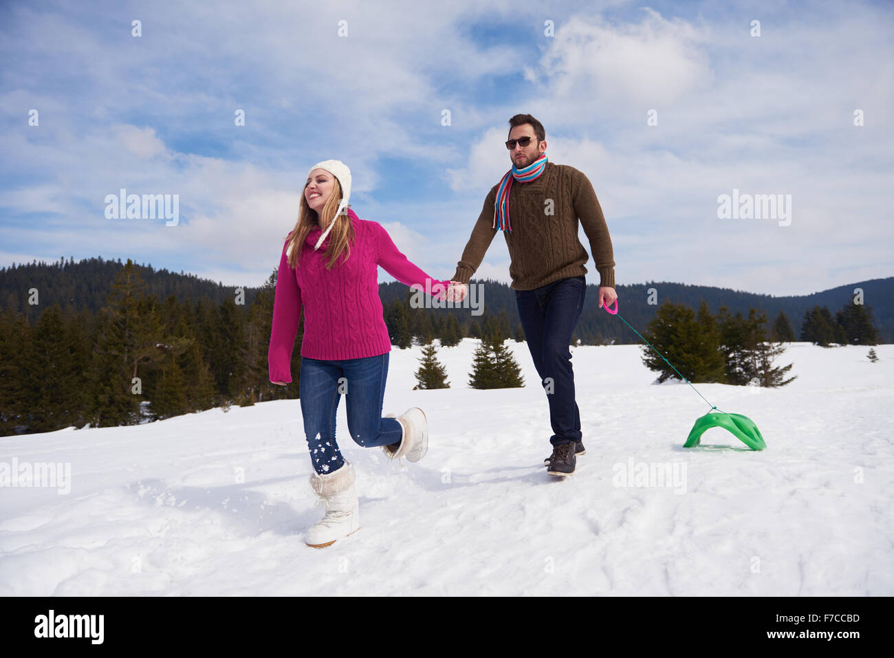 romantic winter scene, happy young couple having fun on fresh show on ...