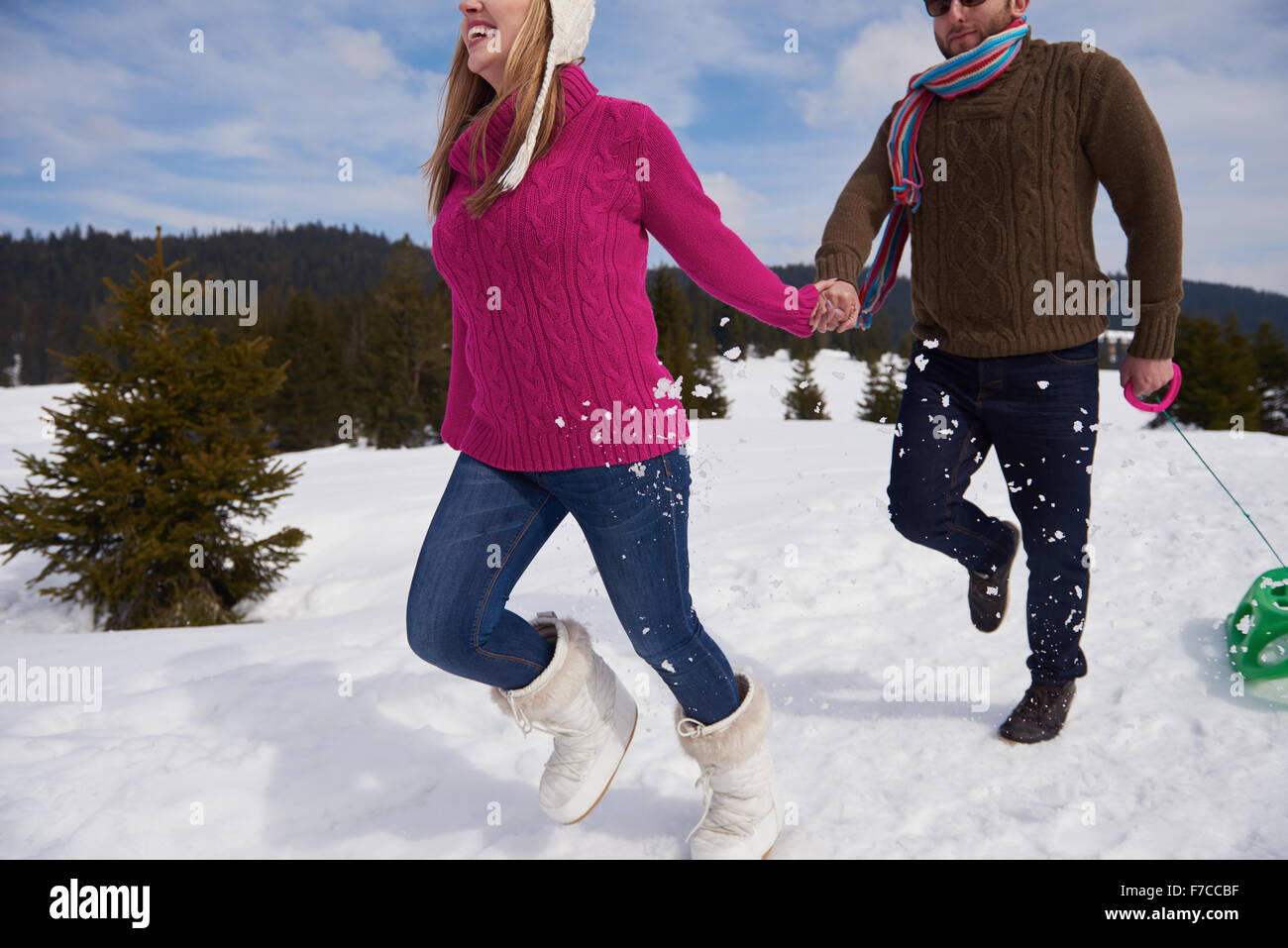 romantic winter scene, happy young couple having fun on fresh show on ...