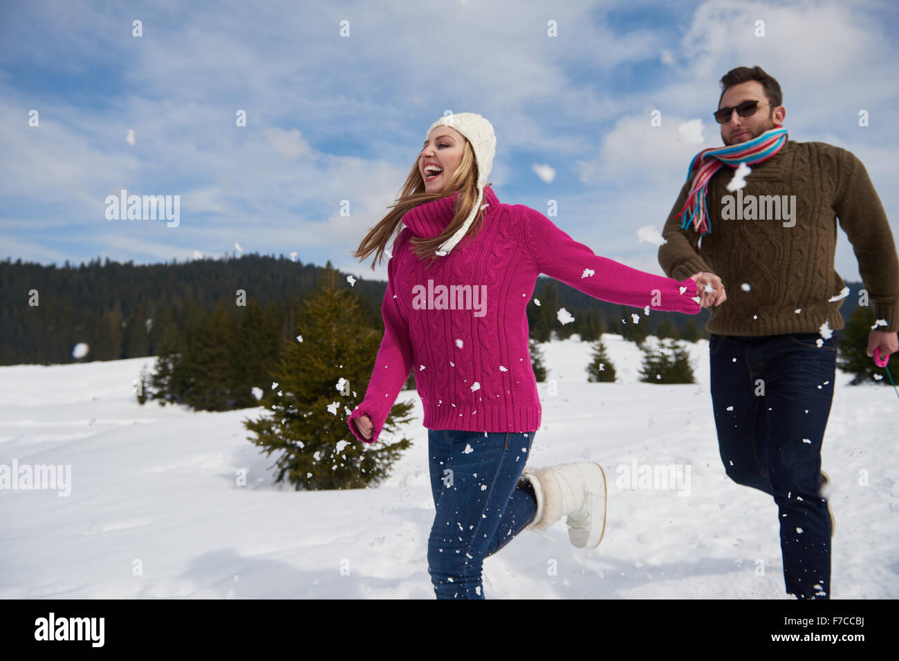 romantic winter scene, happy young couple having fun on fresh show on ...