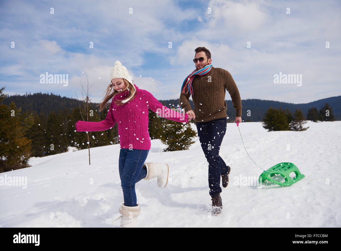 romantic winter scene, happy young couple having fun on fresh show on ...