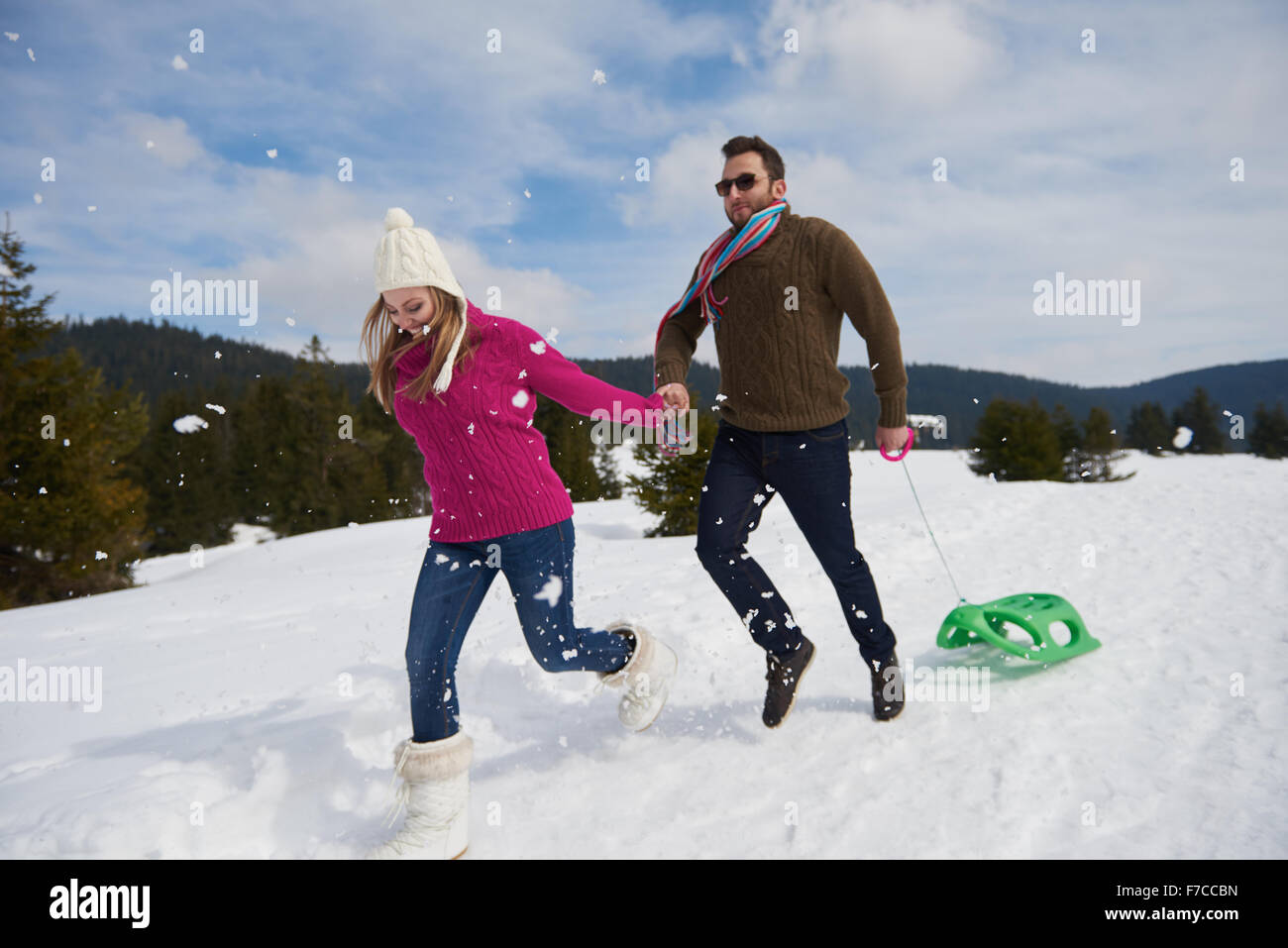 romantic winter scene, happy young couple having fun on fresh show on ...