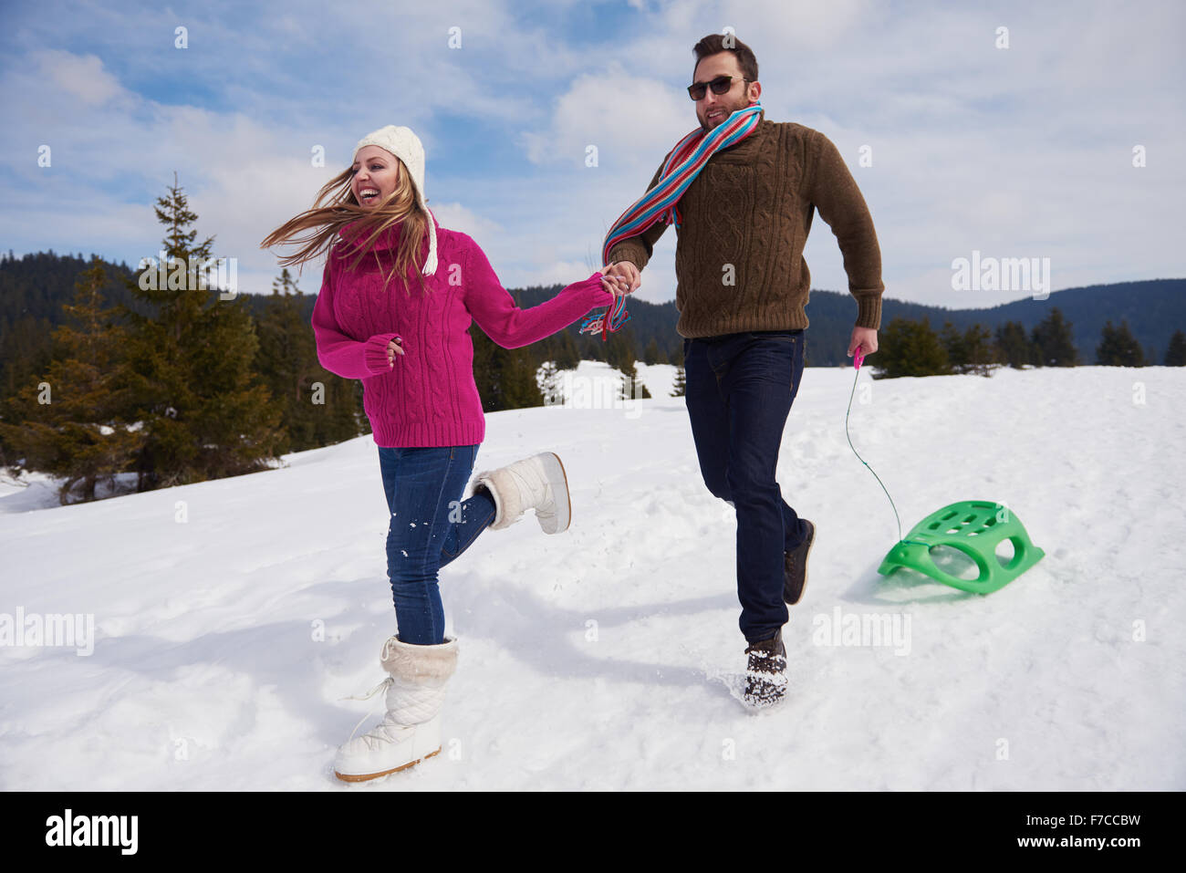 romantic winter scene, happy young couple having fun on fresh show on ...