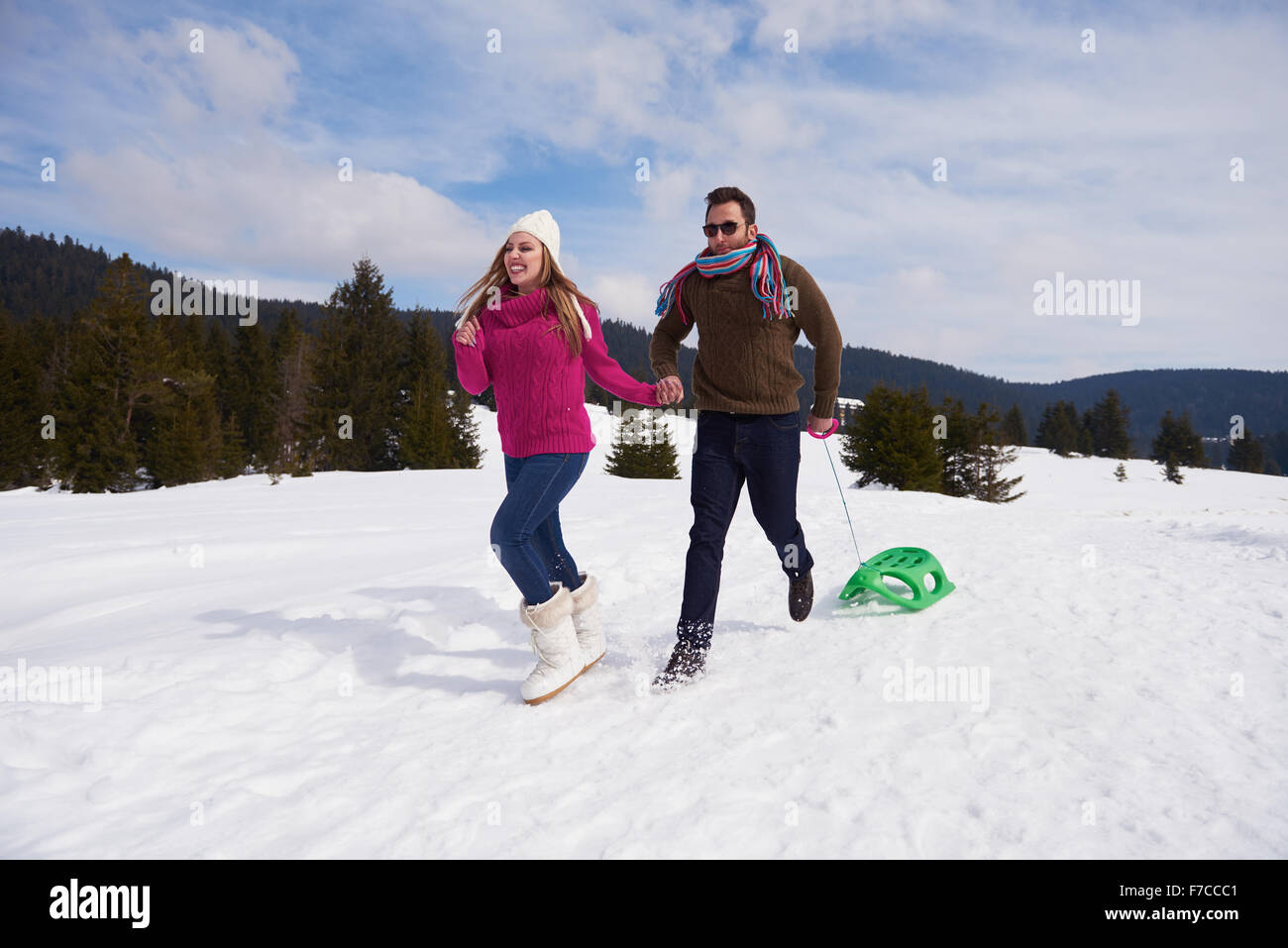 romantic winter scene, happy young couple having fun on fresh show on ...