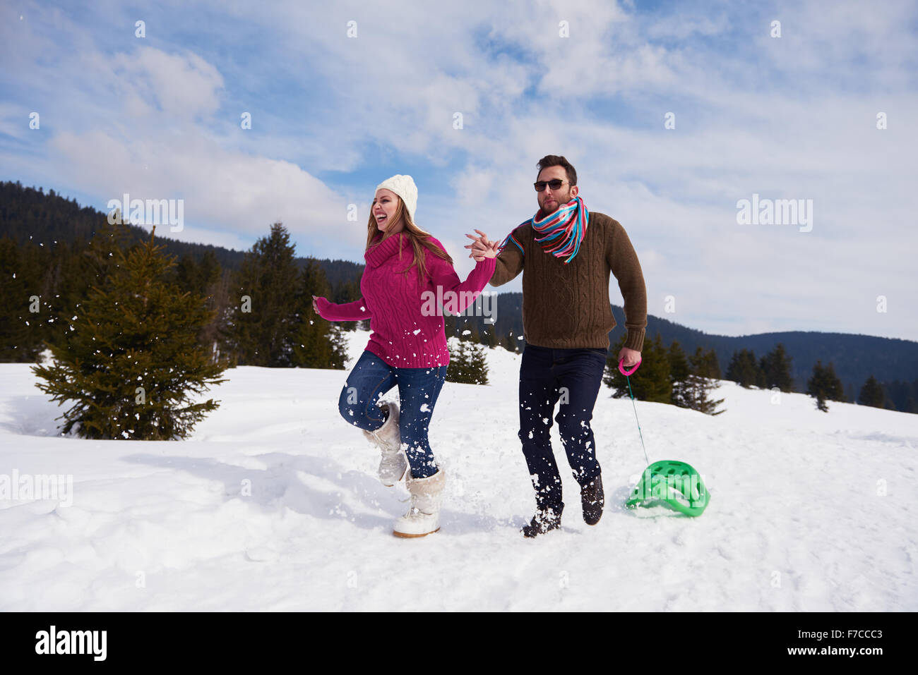 romantic winter scene, happy young couple having fun on fresh show on ...