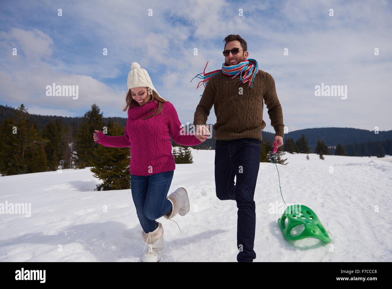 romantic winter scene, happy young couple having fun on fresh show on ...