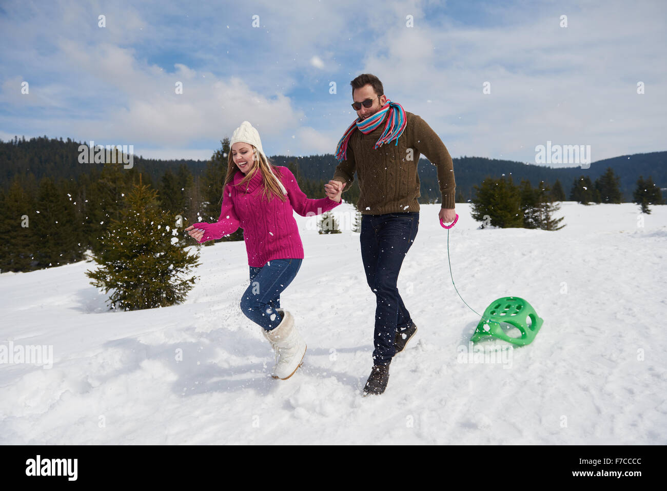romantic winter scene, happy young couple having fun on fresh show on ...