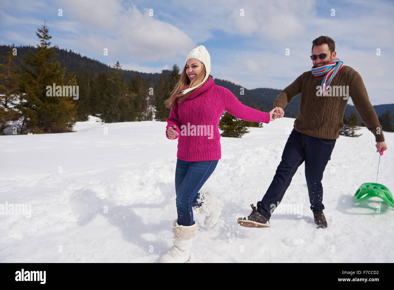 romantic winter scene, happy young couple having fun on fresh show on ...