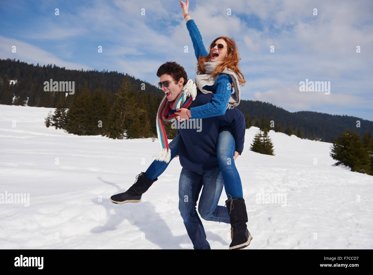 romantic winter scene, happy young couple having fun on fresh show on ...