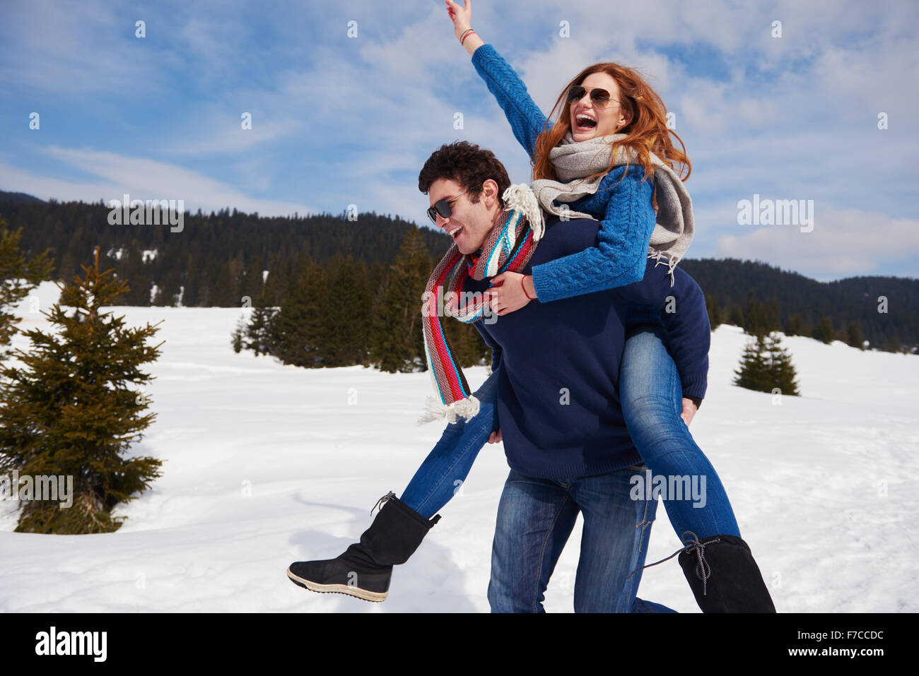 romantic winter scene, happy young couple having fun on fresh show on ...
