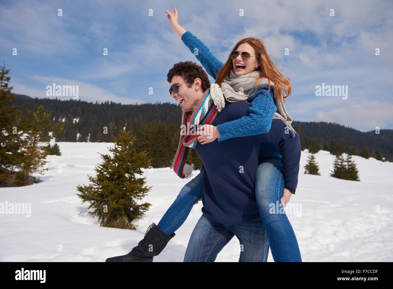 romantic winter scene, happy young couple having fun on fresh show on ...
