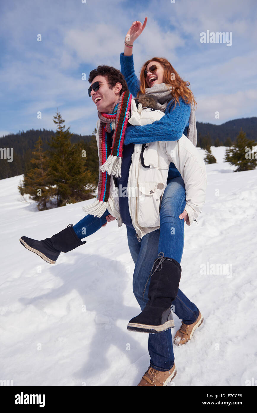 romantic winter scene, happy young couple having fun on fresh show on ...