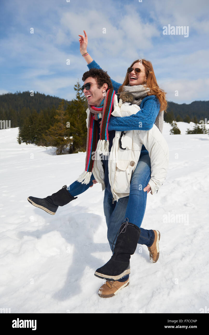 romantic winter scene, happy young couple having fun on fresh show on ...
