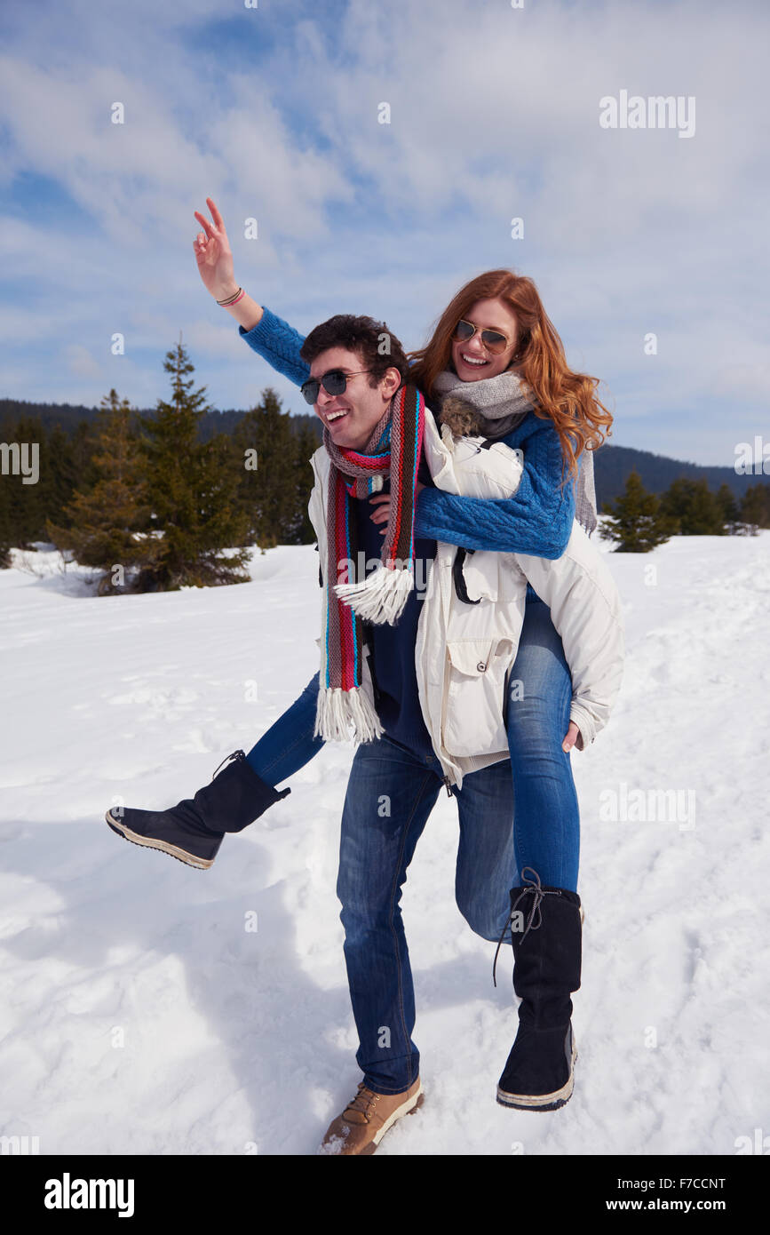 romantic winter scene, happy young couple having fun on fresh show on ...