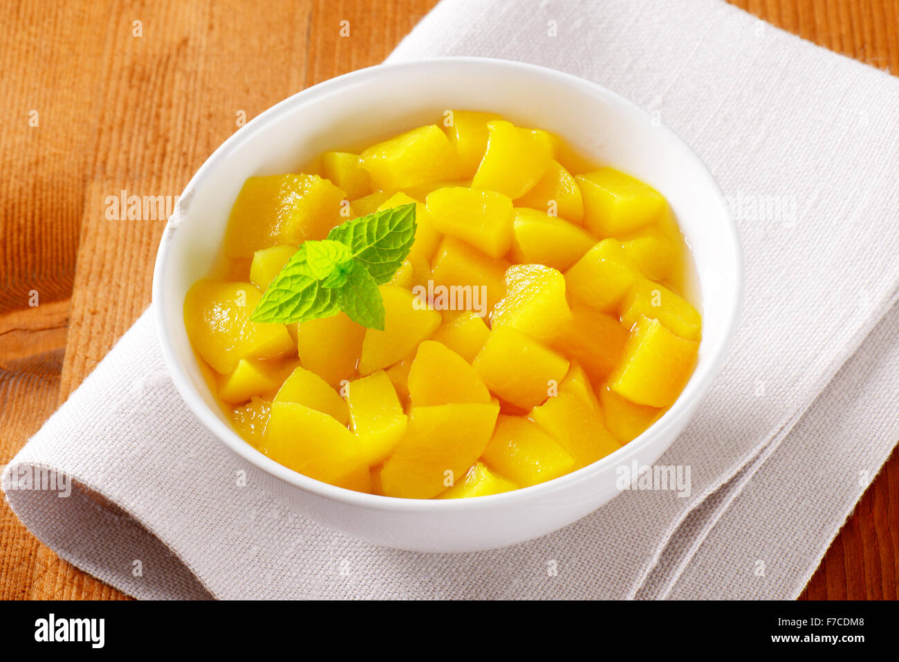 Bowl of diced peach in light syrup Stock Photo - Alamy