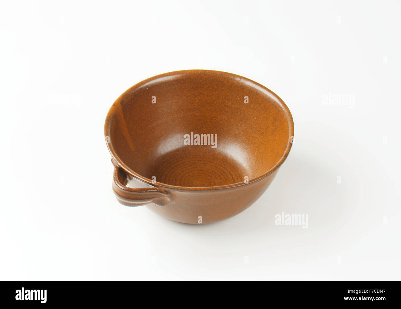 Deep round brown pottery dish Stock Photo - Alamy