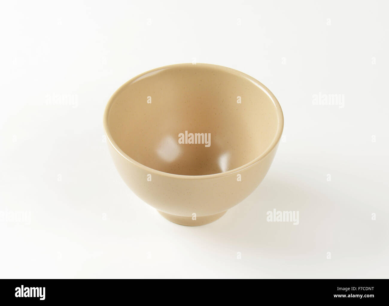 Empty beige bowl on white background Stock Photo - Alamy