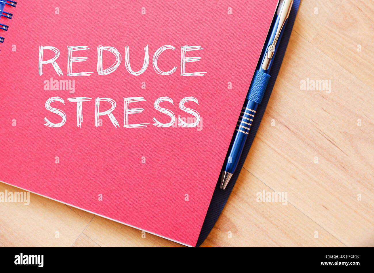 Reduce stress text concept write on notebook with pen Stock Photo - Alamy