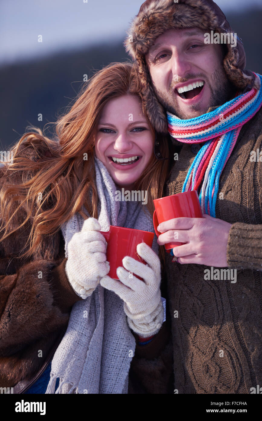 portrait of happy young couple outdoor on winter day drinking warm tea ...