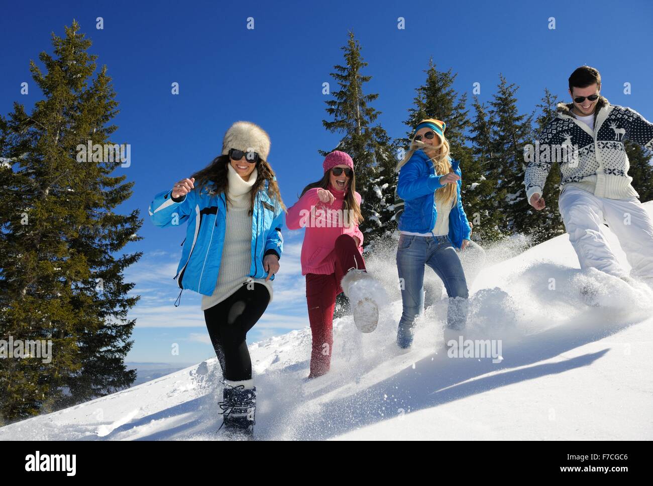 happy friends have fun at winter on fresh snow, healthy young people ...