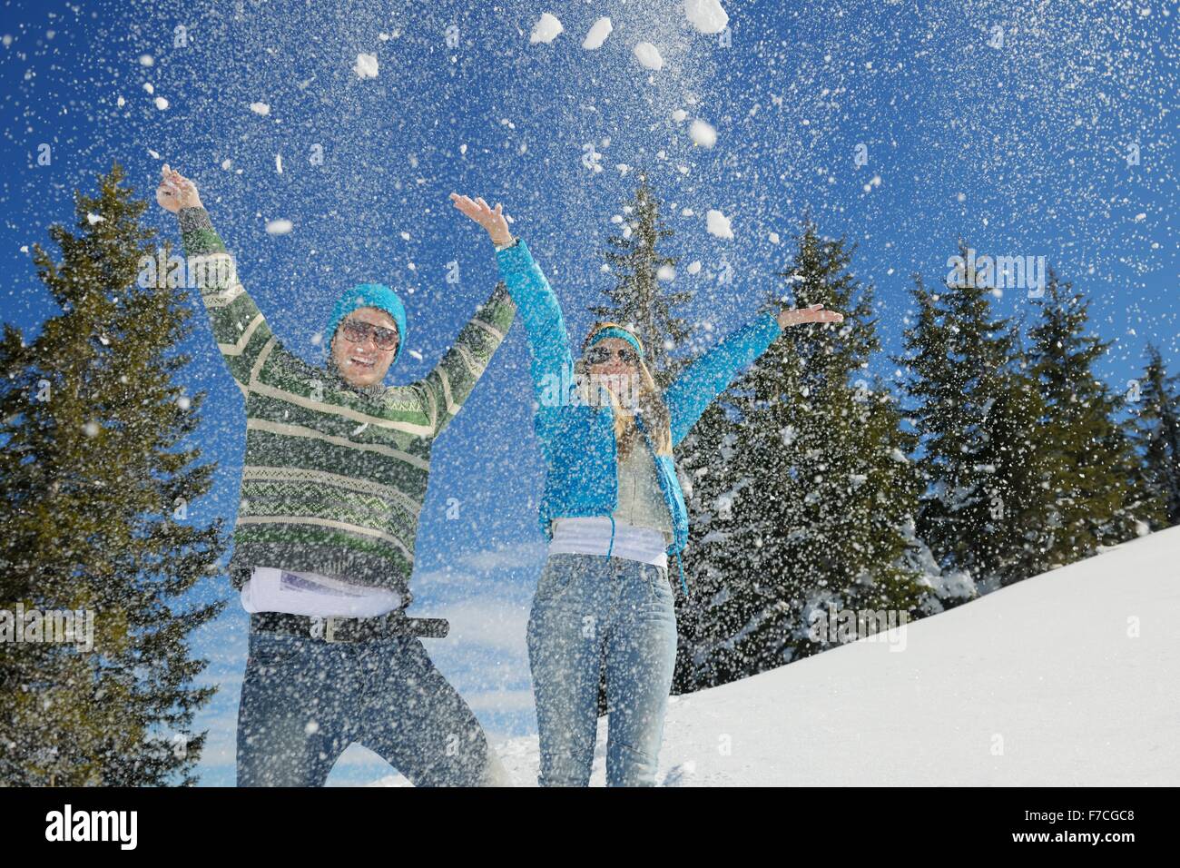 happy friends have fun at winter on fresh snow, healthy young people ...