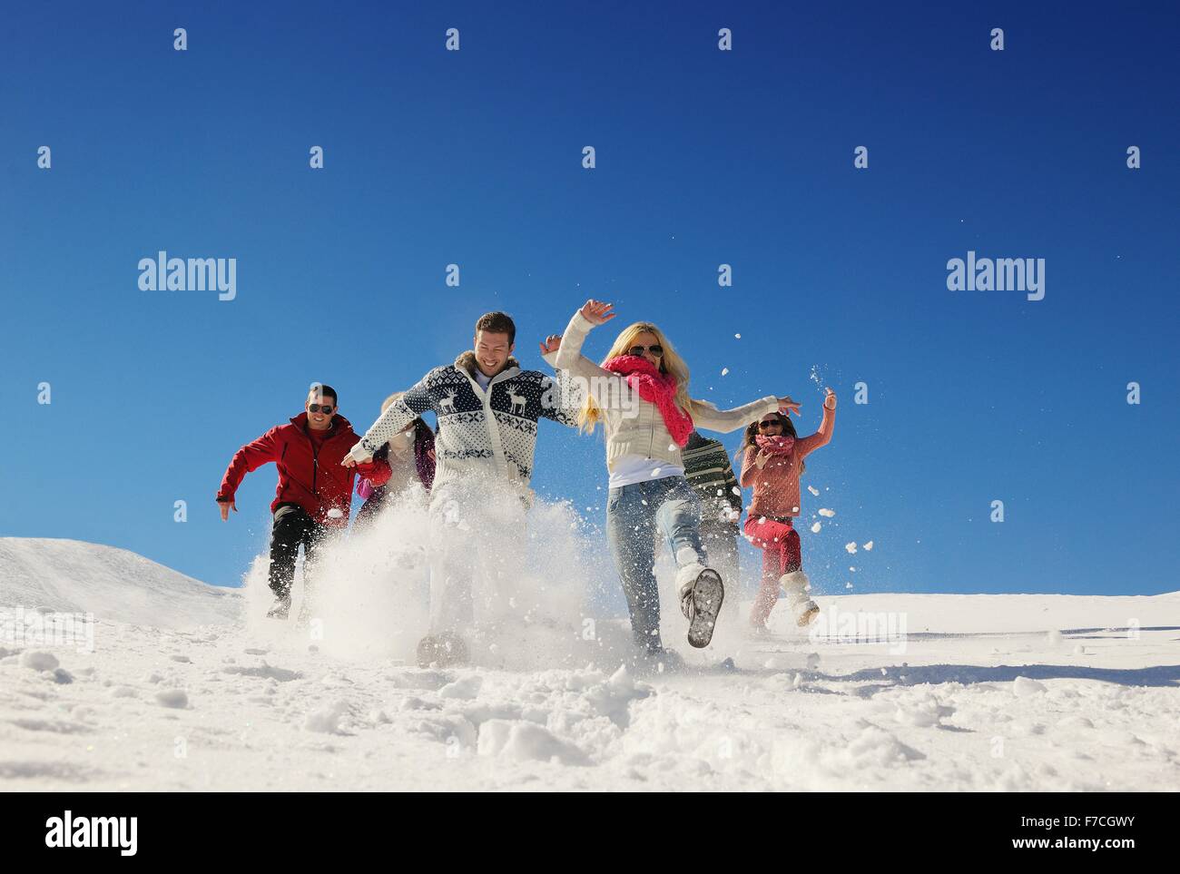 happy friends group have fun at winter on fresh snow, healthy young ...