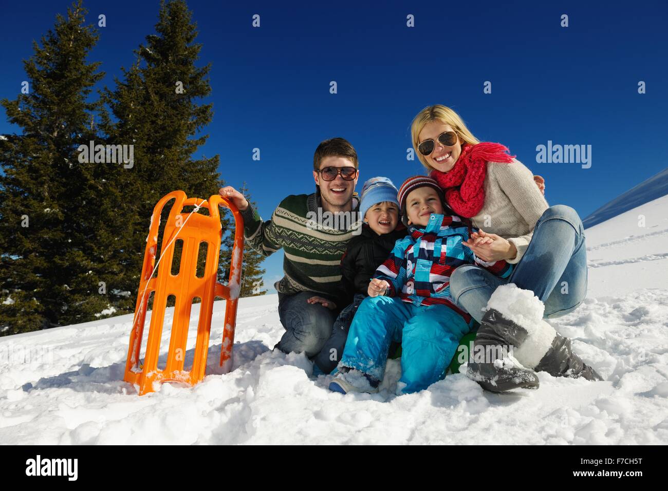 Winter season. Happy family having fun on fresh snow on vacation Stock ...