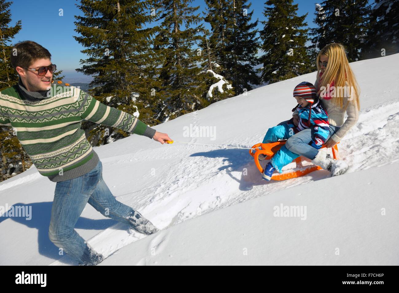 Winter season. Happy family having fun on fresh snow on vacation Stock ...