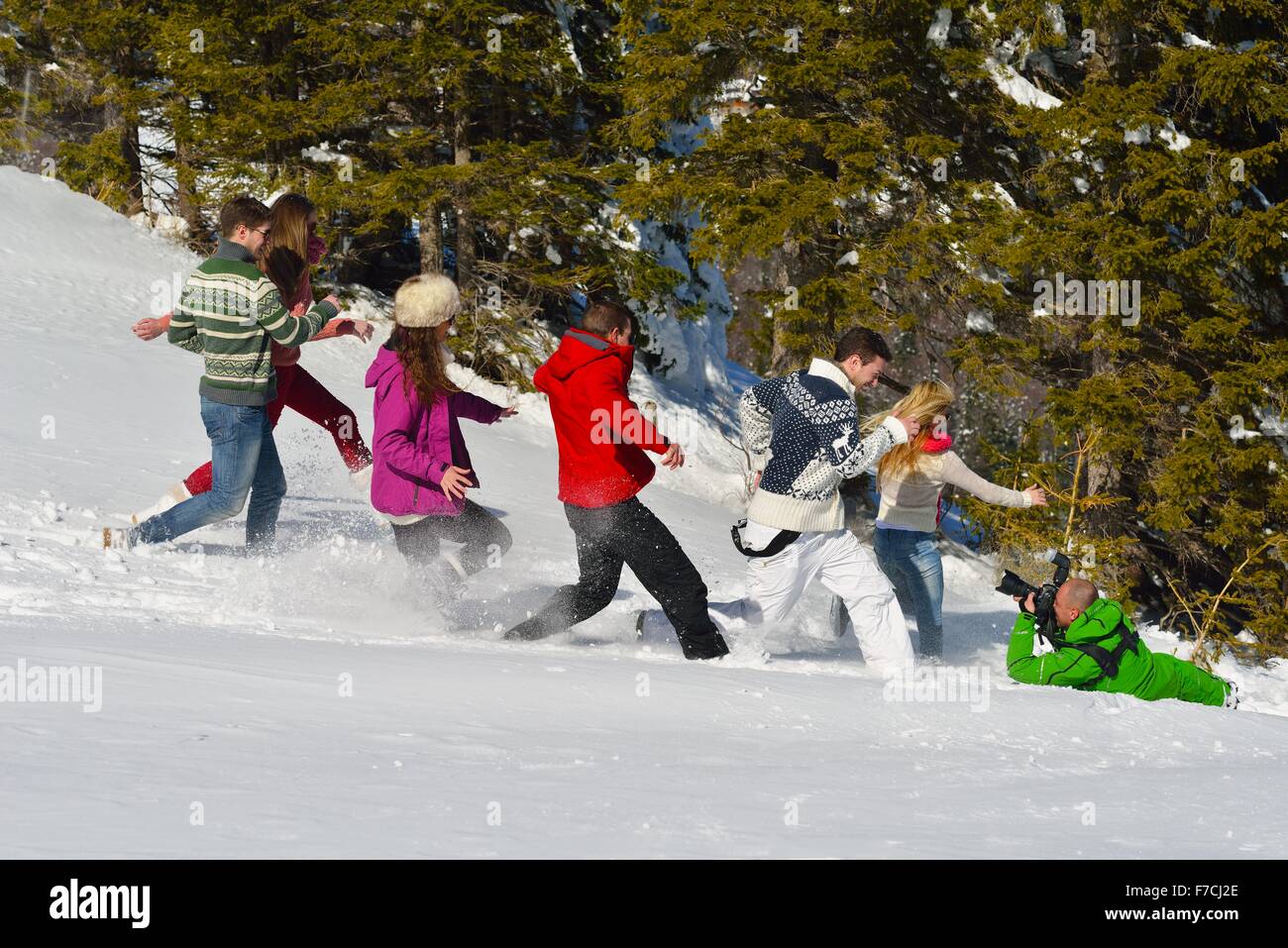 happy friends group have fun at winter on fresh snow, healthy young ...