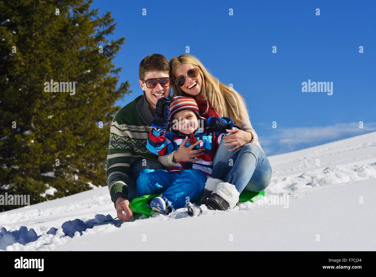 Winter season. Happy family having fun on fresh snow on vacation Stock ...