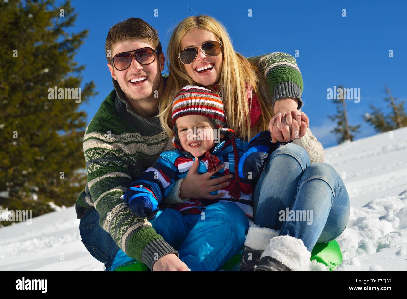 Winter season. Happy family having fun on fresh snow on vacation Stock ...