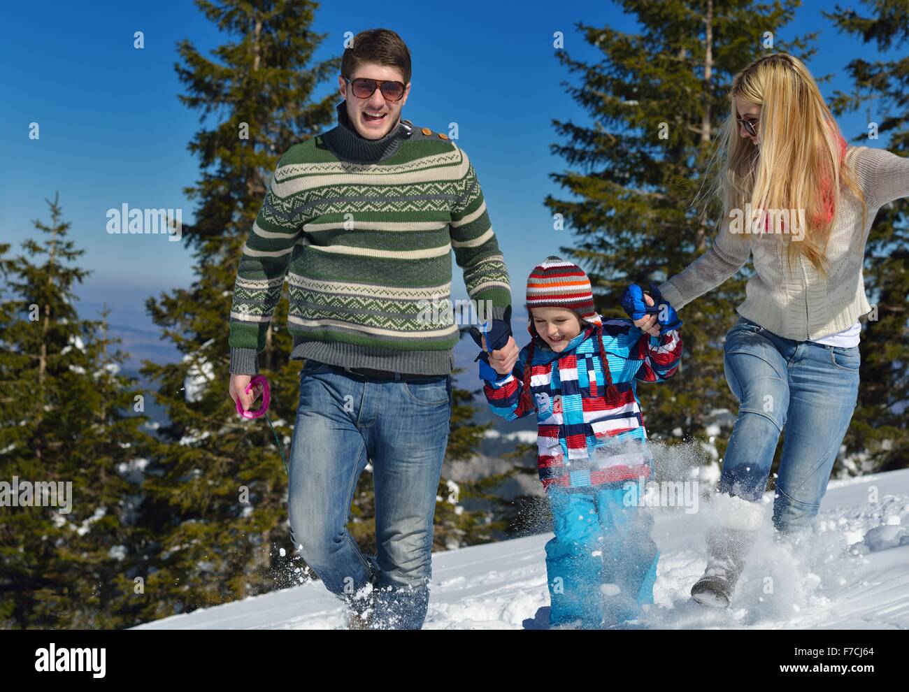 Winter season. Happy family having fun on fresh snow on vacation Stock ...