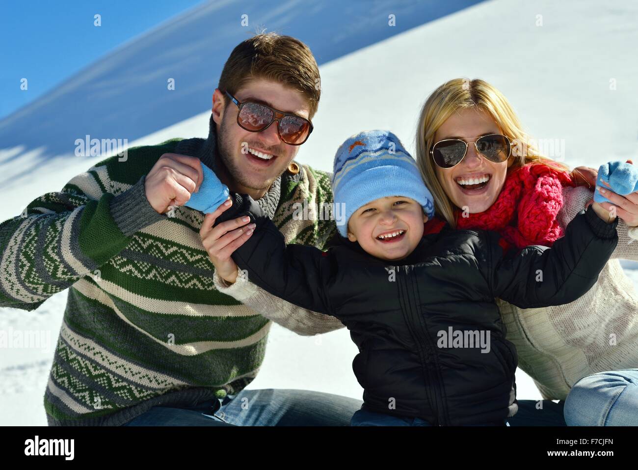 Winter season. Happy family having fun on fresh snow on vacation Stock ...