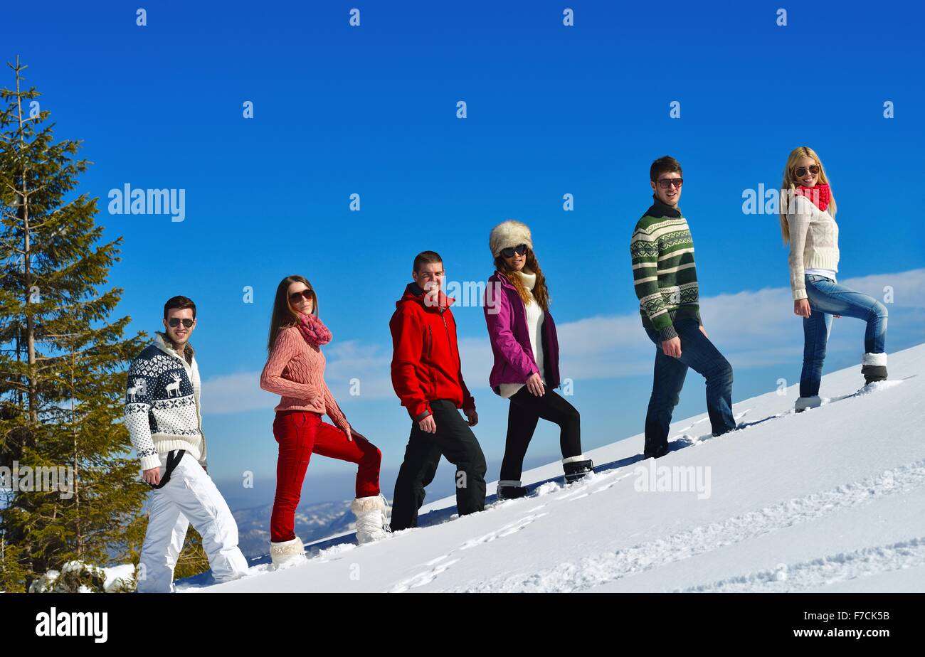 happy friends have fun at winter on fresh snow, healthy young people ...