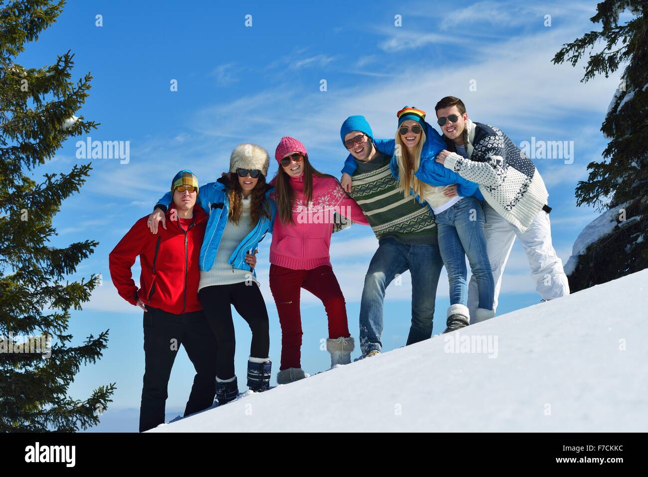 happy friends have fun at winter on fresh snow, healthy young people ...