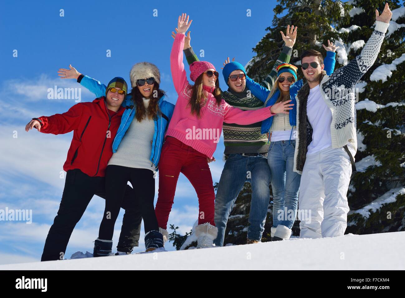 happy friends have fun at winter on fresh snow, healthy young people ...