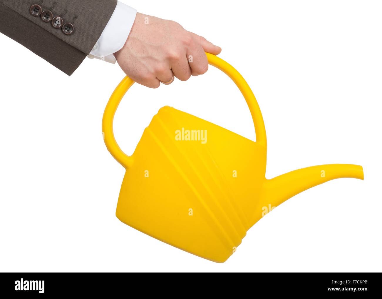 Businessmans hand holding watering-can Stock Photo - Alamy
