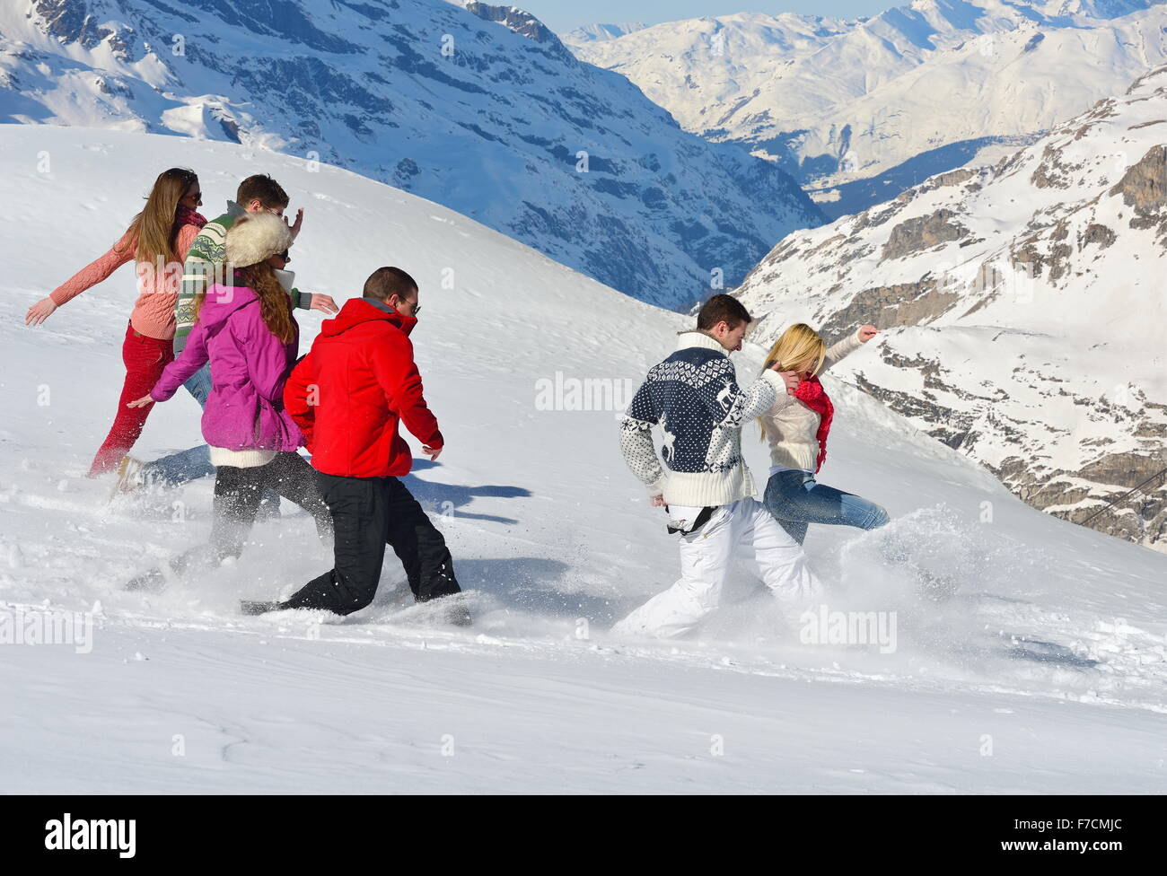 happy friends group have fun at winter on fresh snow, healthy young ...