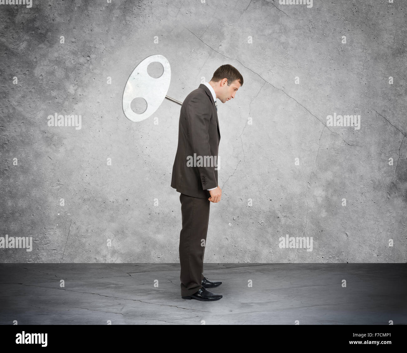 Businessman with key in back looking down Stock Photo - Alamy