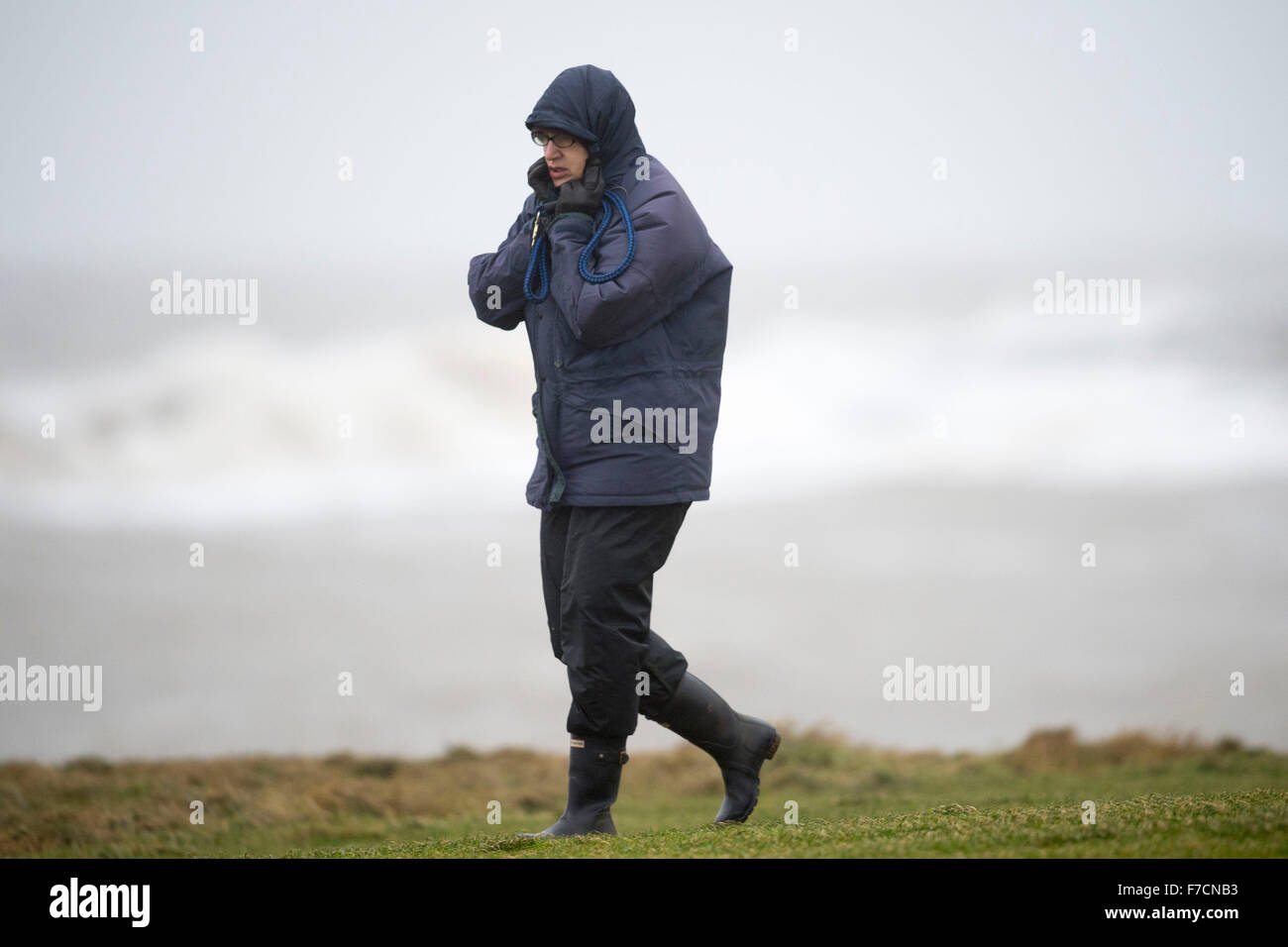 A walker is blown in strong winds during storm Clodagh at Porthcawl ...