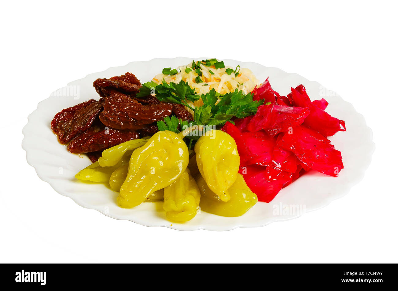 different colored pickles on the plate, isolated on white background ...