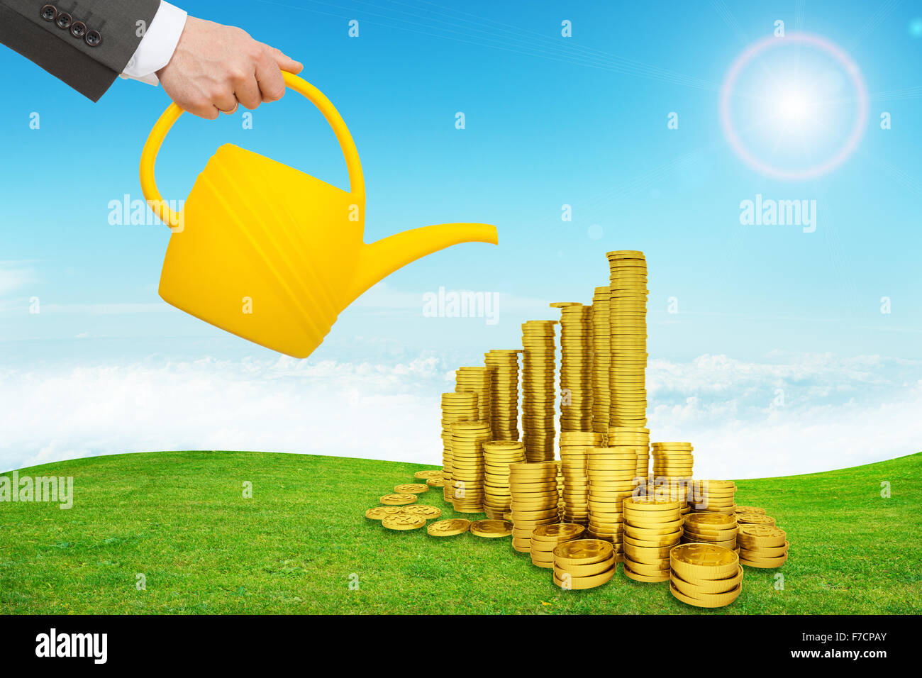 Hand with can watering coins Stock Photo - Alamy