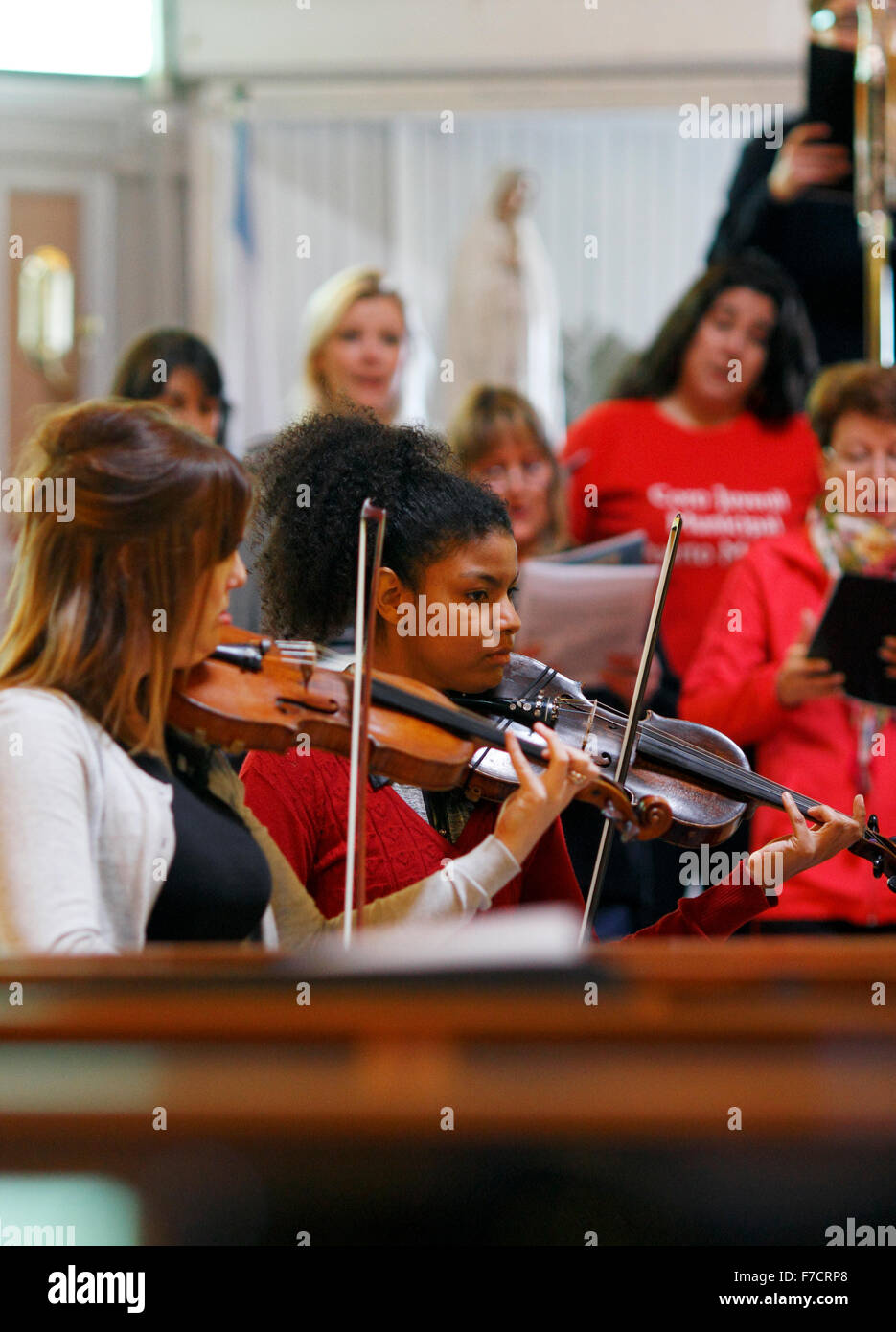 Two young women playing violin in a rehearsal Stock Photo - Alamy