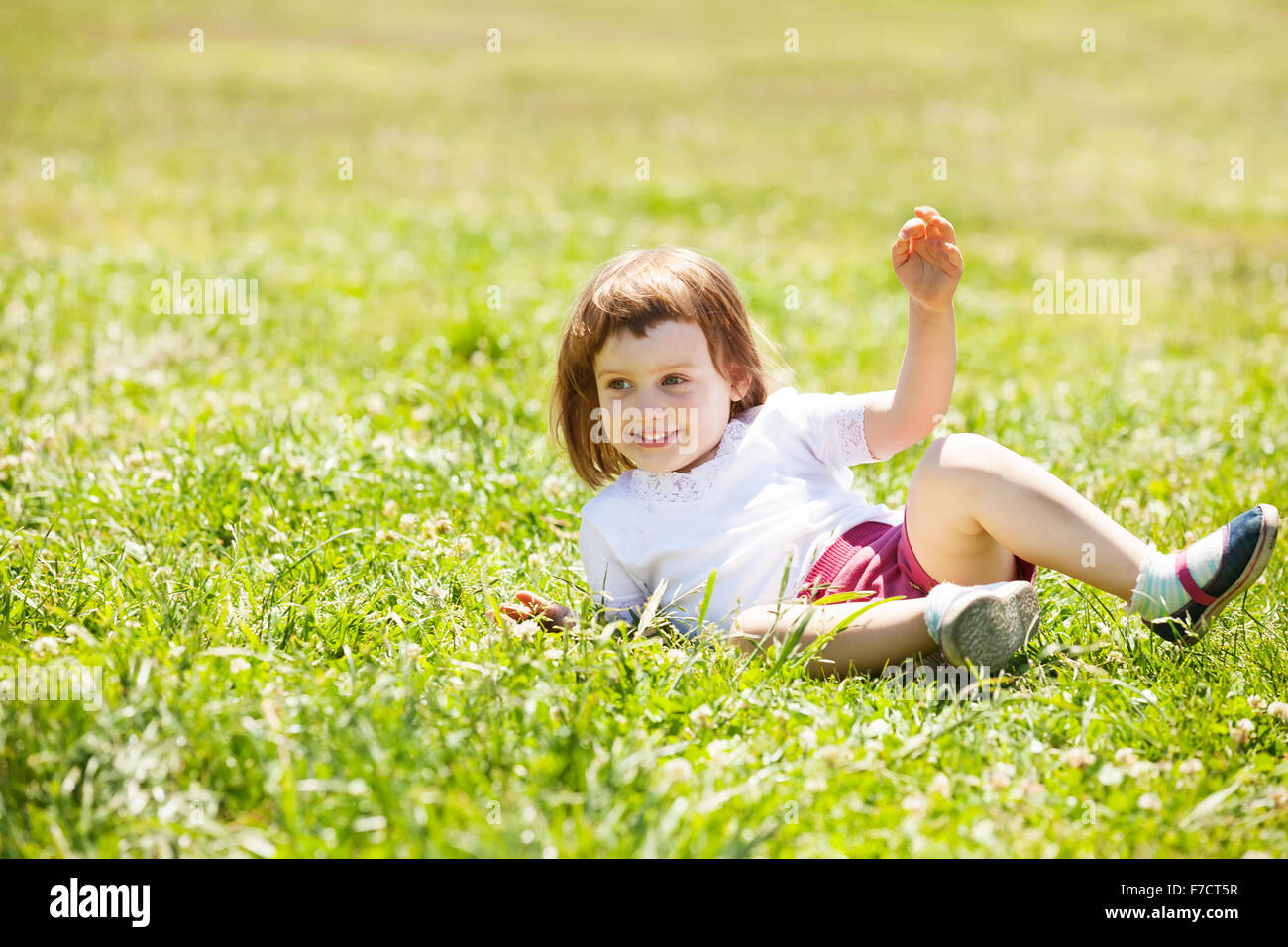 happy three year old child playing at grass meadow in summer Stock ...